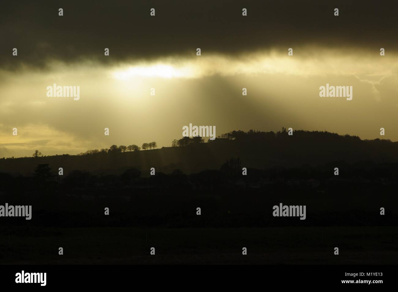 Light Golden Sunset and Sunrays from Brooding Ominous Stratus ...