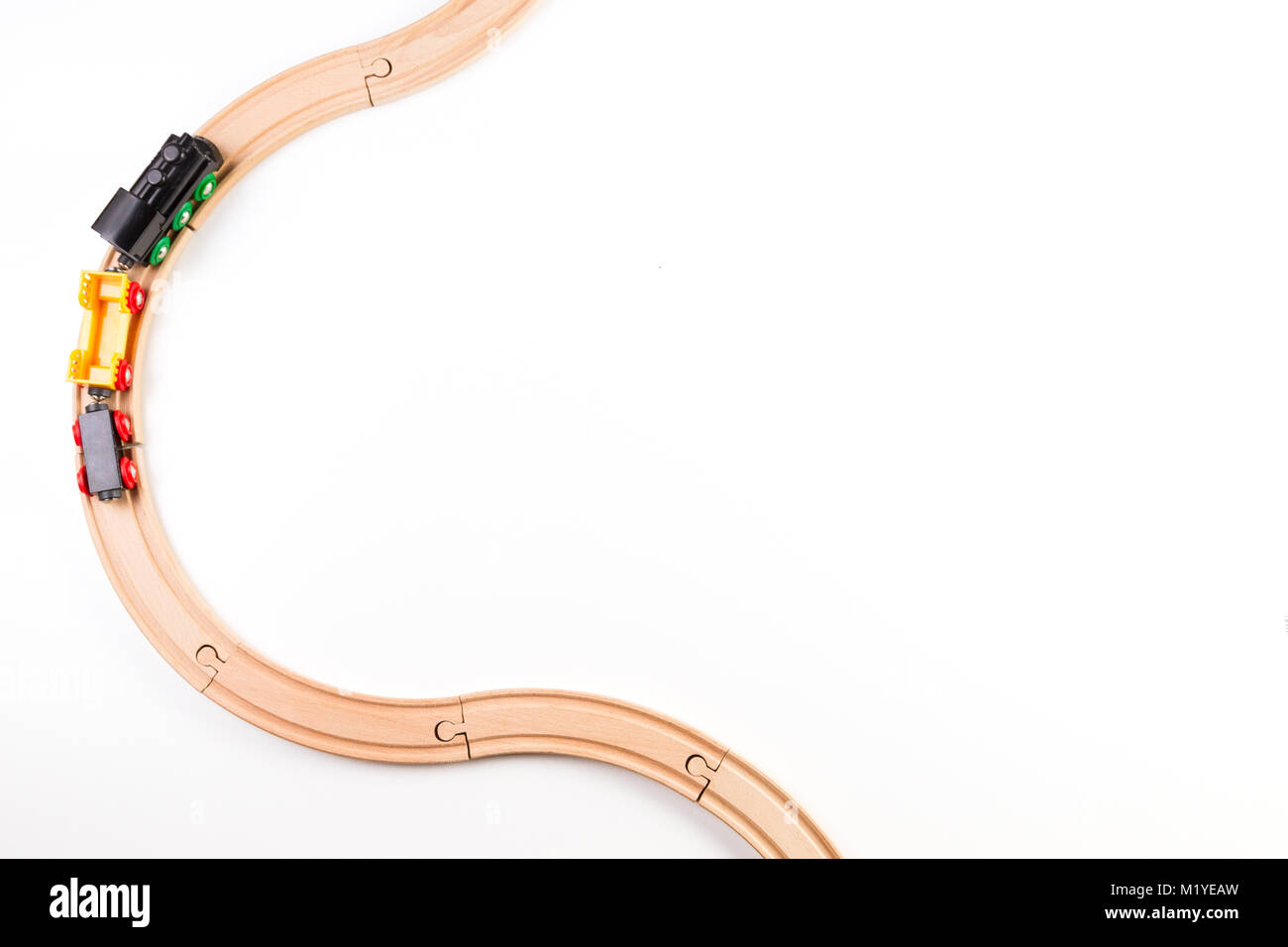 Toy train on curve wooden railways. Top view Stock Photo - Alamy