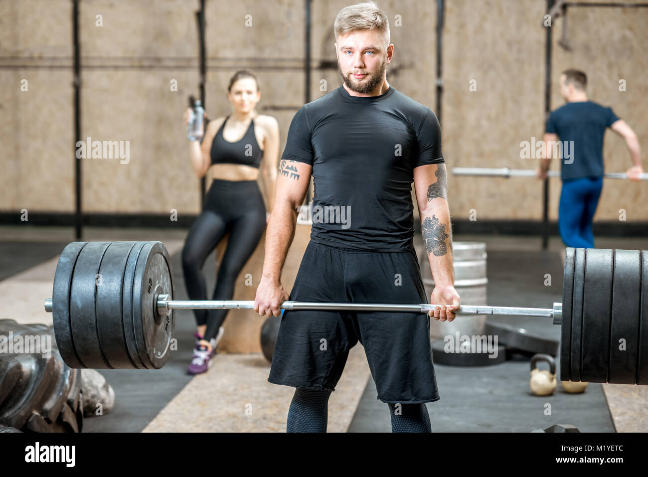 Man lifting up a burbell in the gym Stock Photo - Alamy