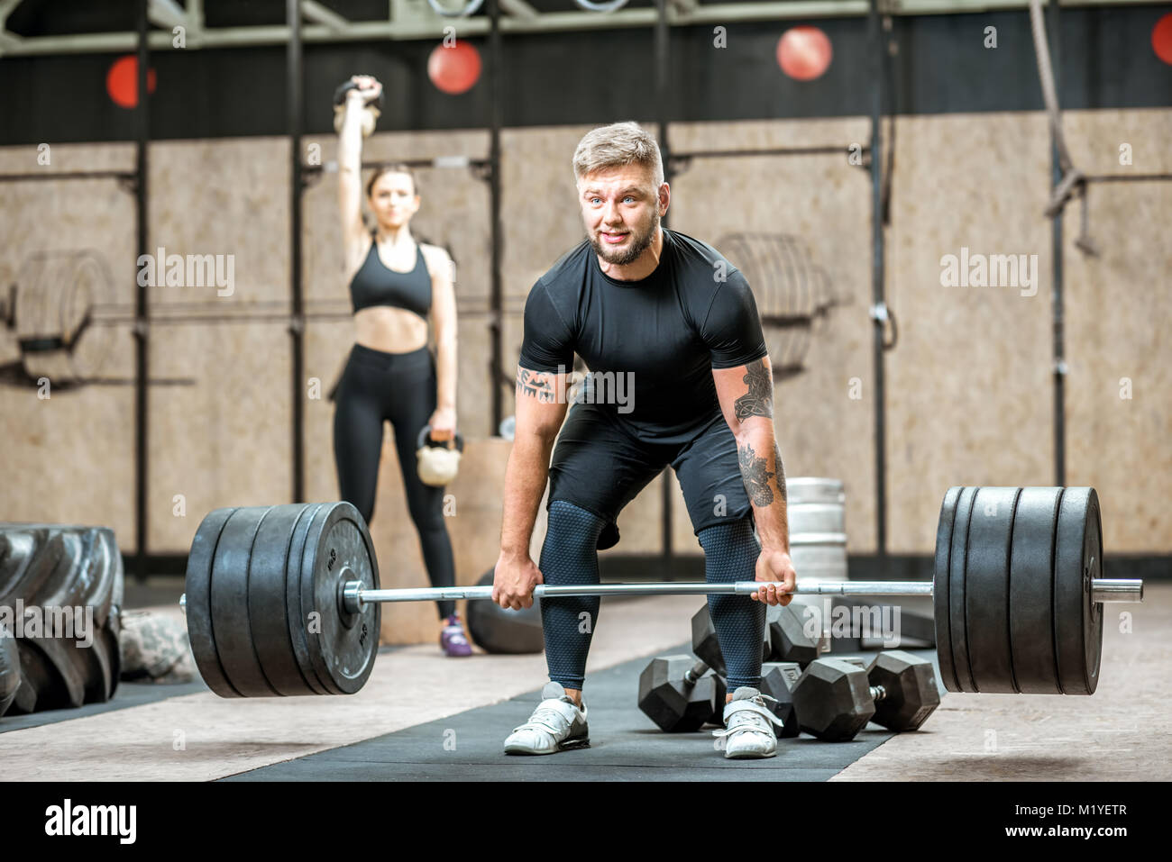 Man lifting up a burbell in the gym Stock Photo - Alamy