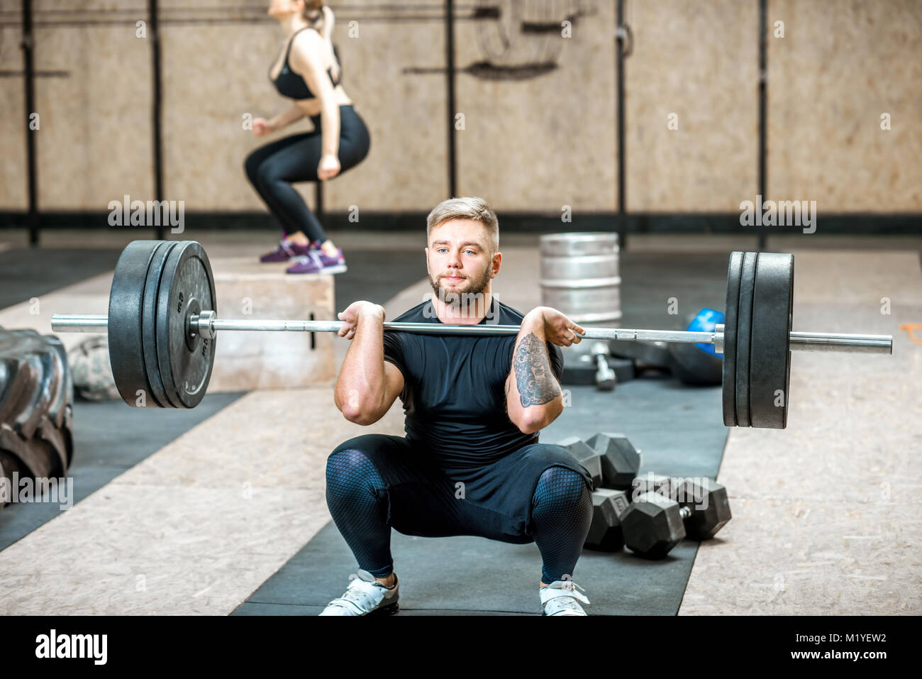 Man lifting up a burbell in the gym Stock Photo - Alamy