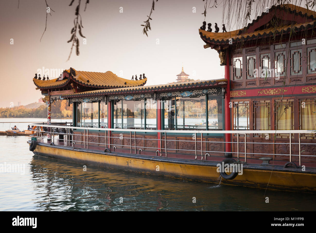 Chinese wooden floating restaurant moored near West Lake coast. Famous ...