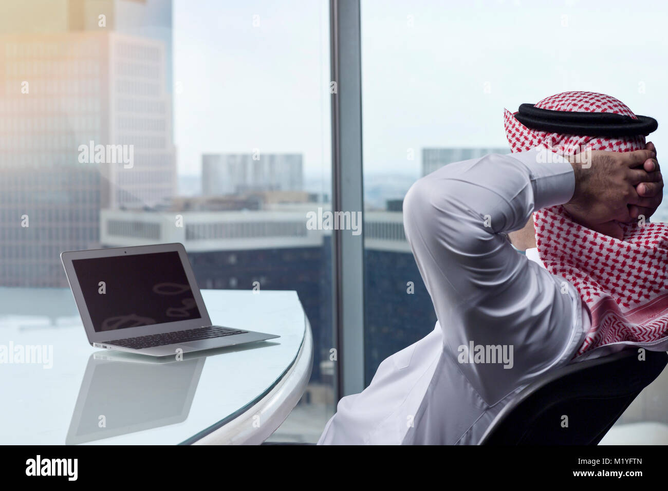 Saudi Arab Man Watching Laptop at Work and Contemplating Stock Photo ...