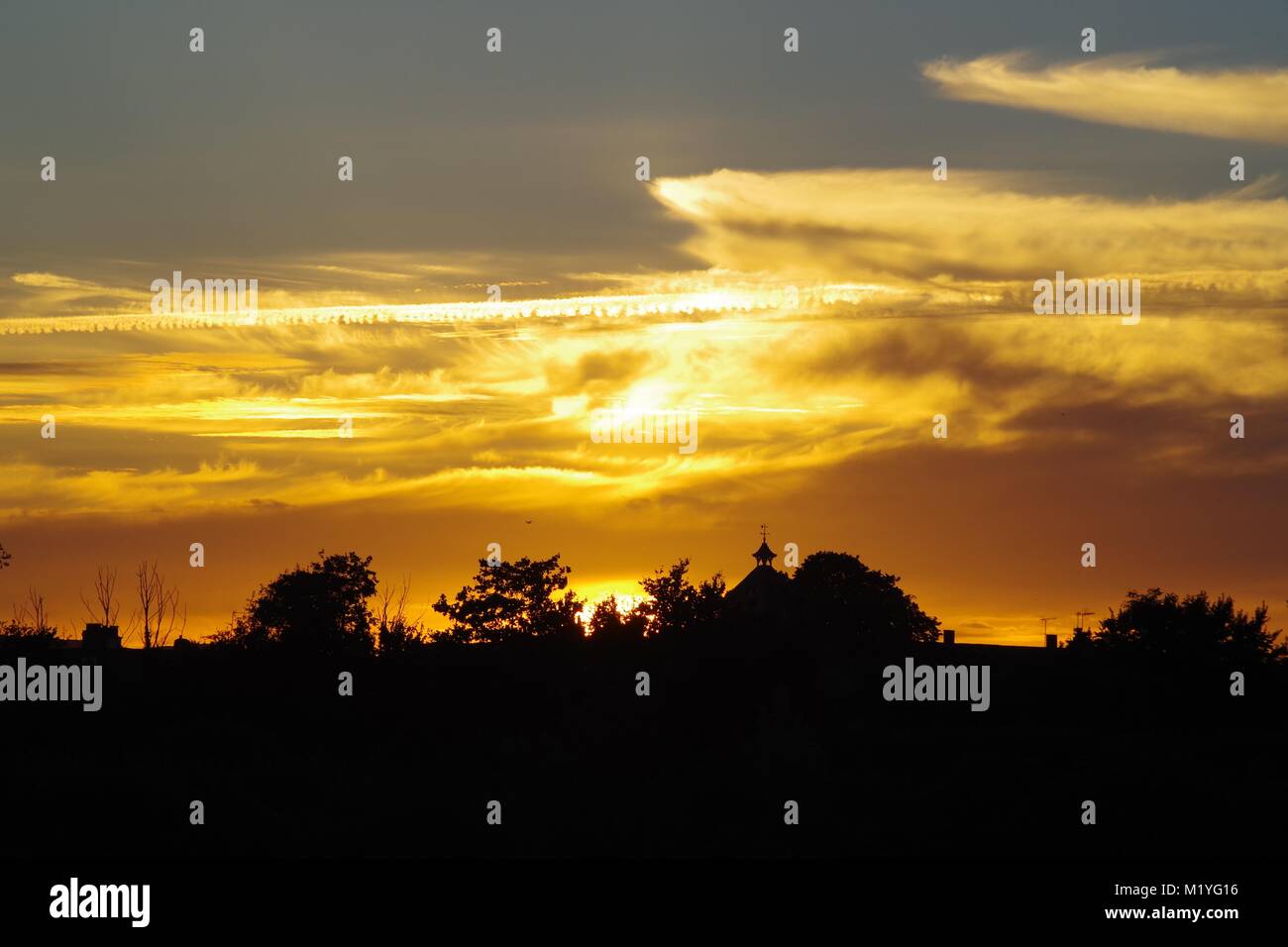 A Beautiful Firery Sunset, Silhouetting the Treeline and a Country ...