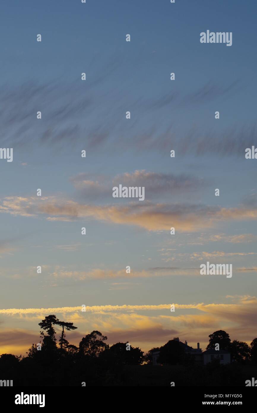 Subtle Sunset with Interesting Clouds and a Silhouetted Hedge Row on a ...