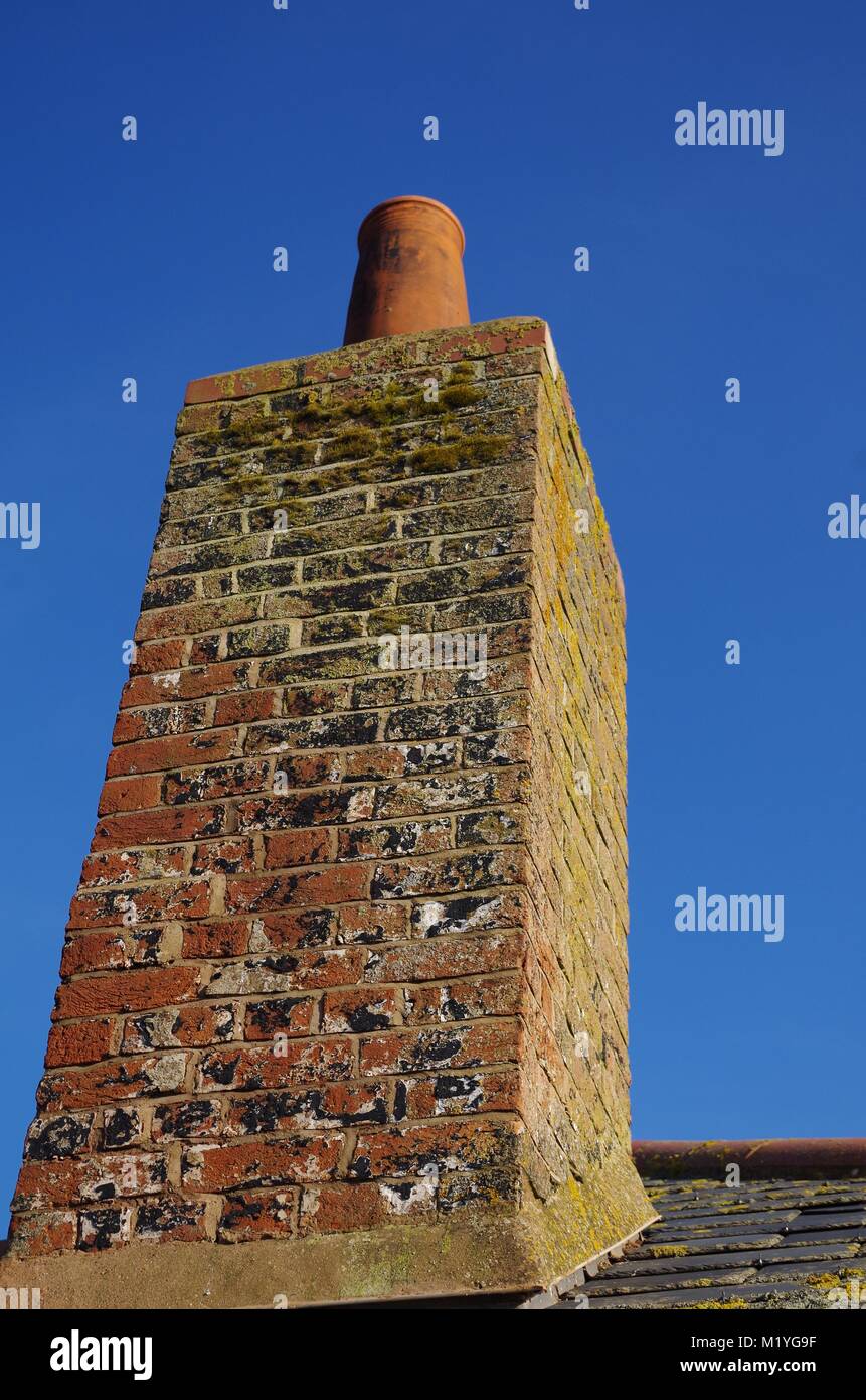 Old Brick Chimney and Chimney Pot in the Golden Light of Dusk against a ...