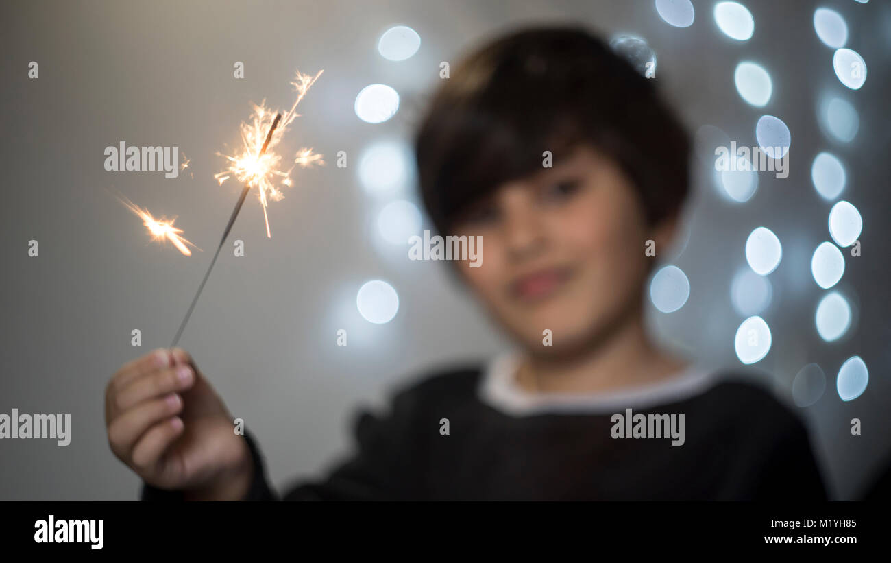 Boy holding fireworks sparklers hi-res stock photography and images - Alamy