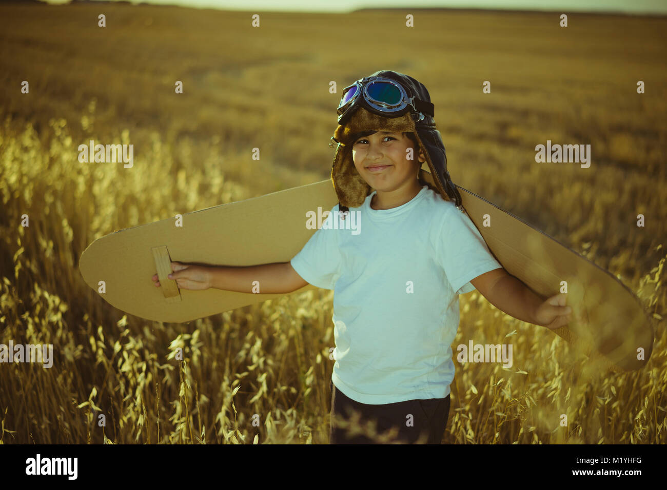Vintage, Boy playing to be airplane pilot, funny guy with aviator cap ...