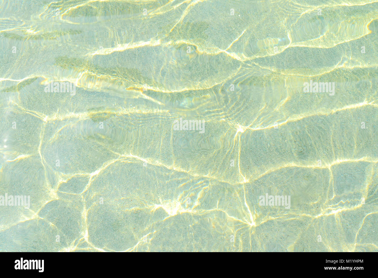 Swimming pool blue water with a wave and sunlight reflection effect ...