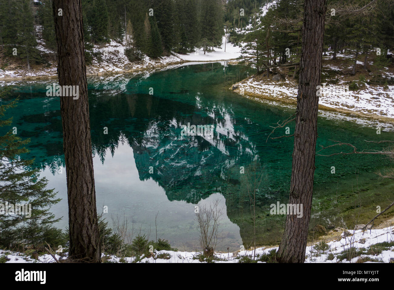 The Austrian Alps reflected in the amazing turquoise waters of the ...