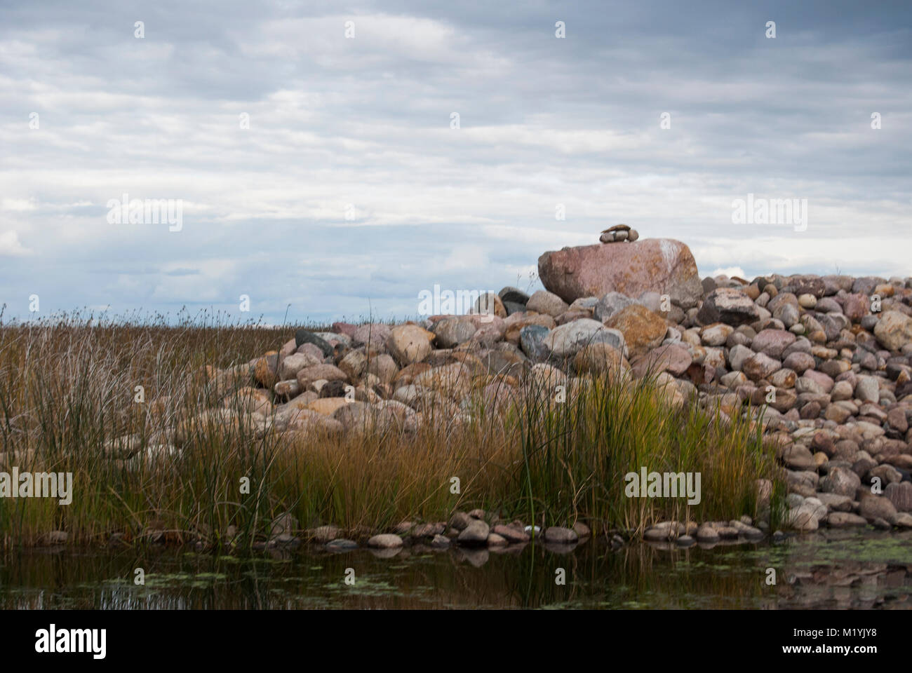 Rocks piles on the shore of Lesser Slave Lake,Alberta,Canada, from ...