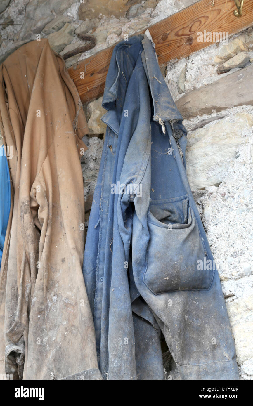 old farmer's dress hanging on the wall of a farm in the countryside ...