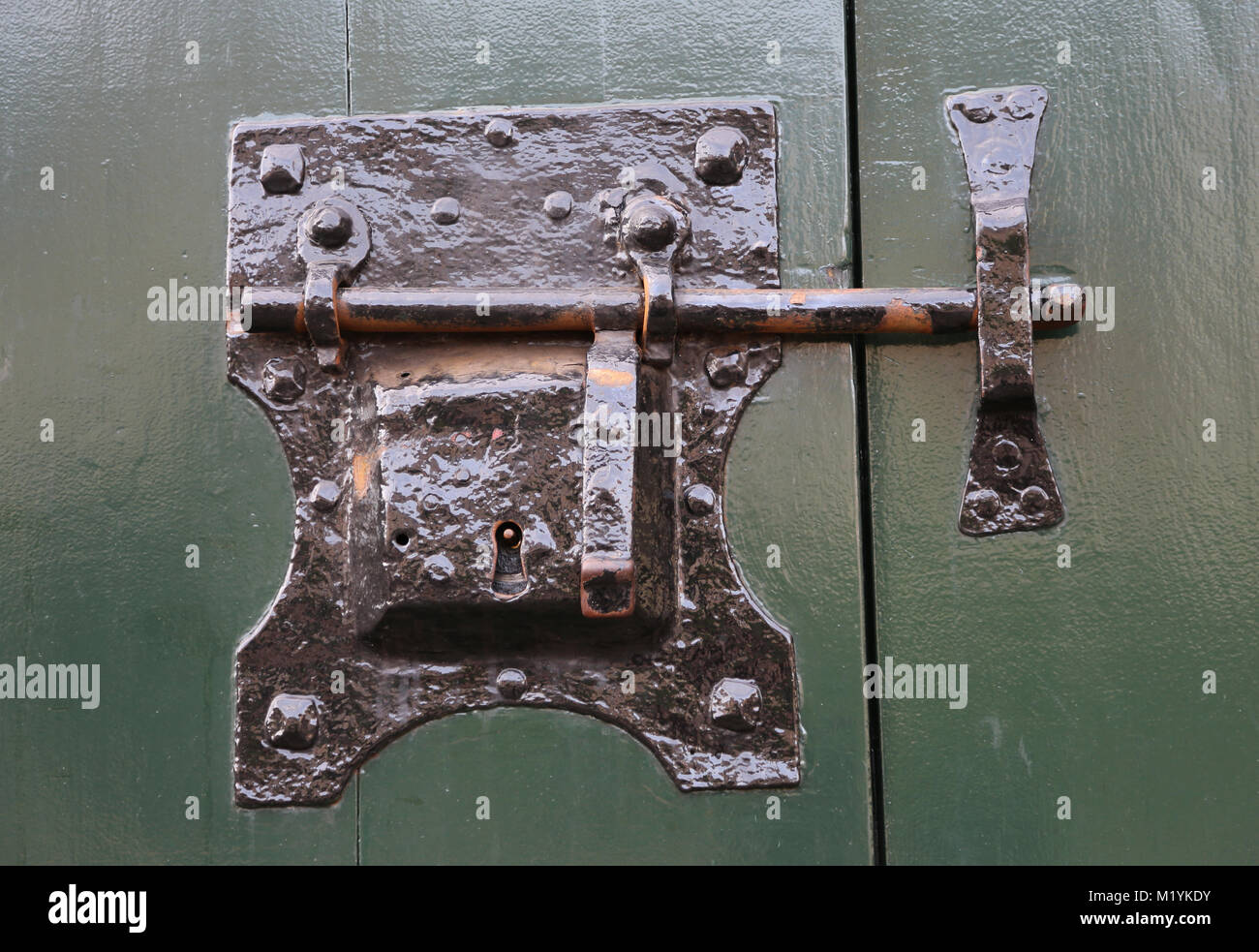 ancient lock that closes the door of an old building Stock Photo - Alamy