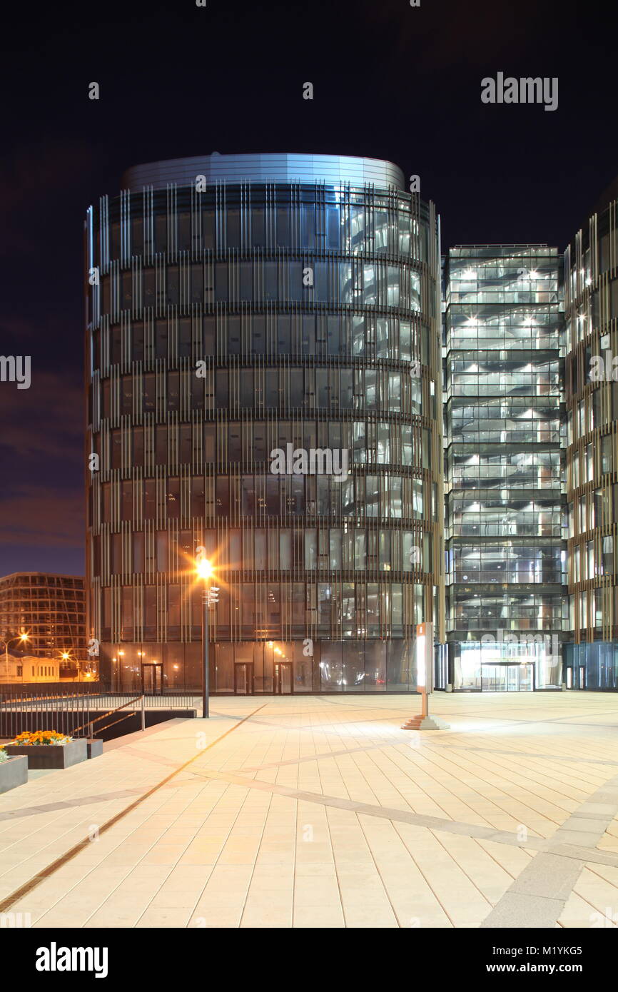 skyscraper with glass walls and steel structure at night Stock Photo ...