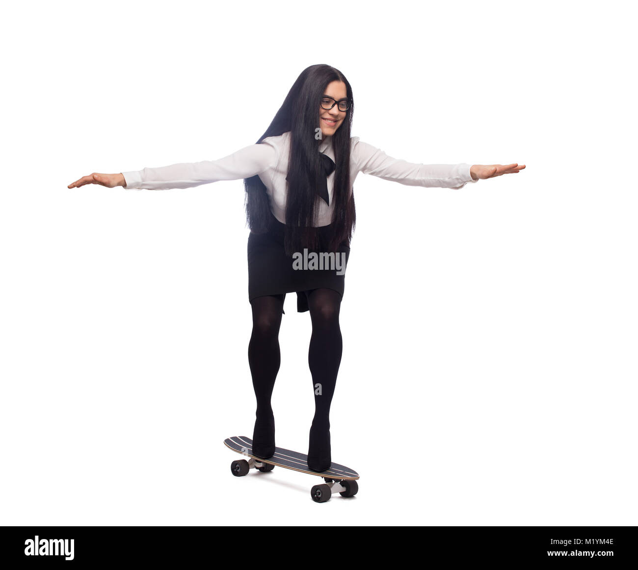 Happy young businesswoman in formal wear riding on skateboard, isolated ...
