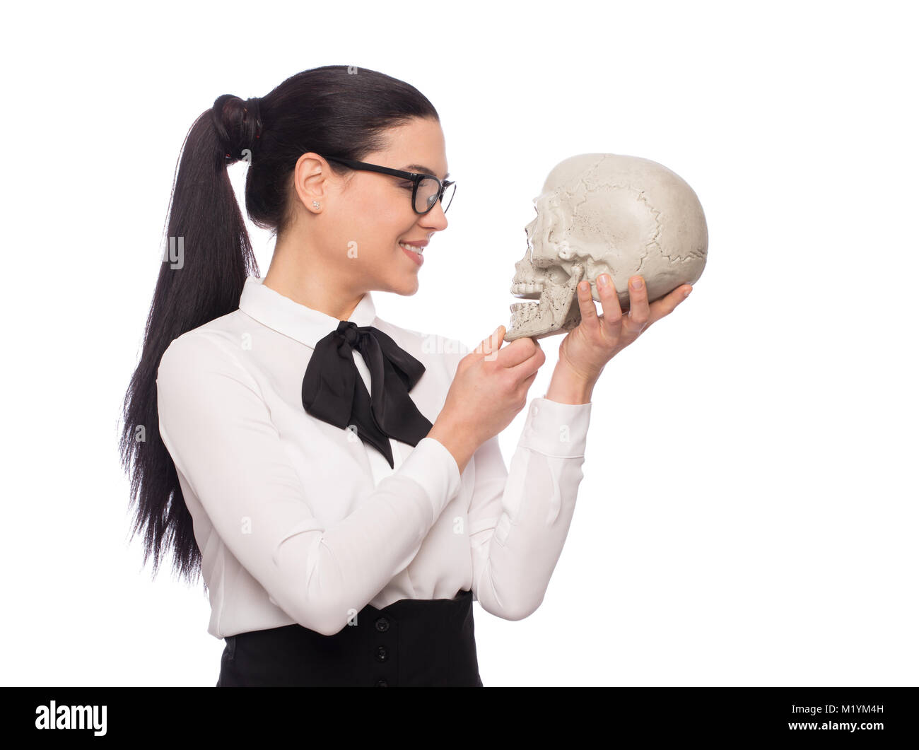 Young businesswoman smiling to skull, isolated on white Stock Photo - Alamy