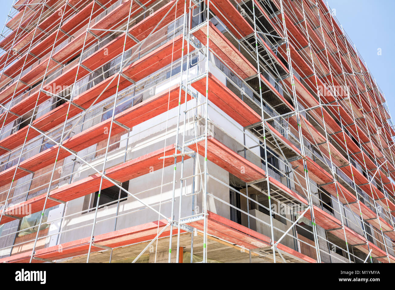 Building construction site with red scaffolding. Building facade Stock ...