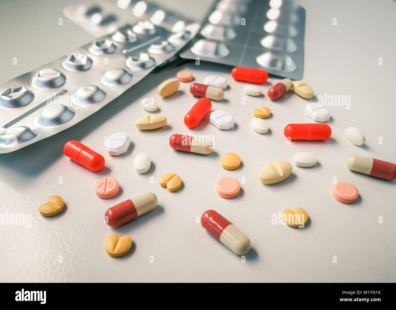 Medication white and colorful tablets arranged abstract on white color ...