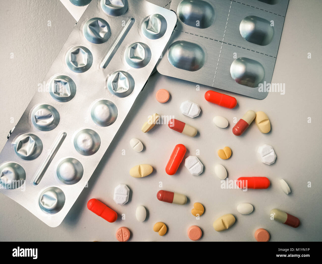 Medication white and colorful tablets arranged abstract on white color ...