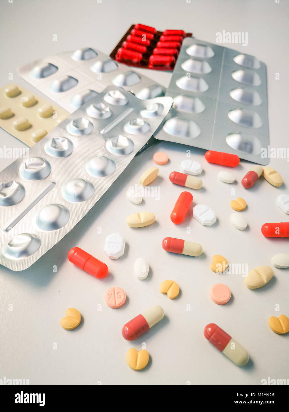 Medication white and colorful tablets arranged abstract on white color ...