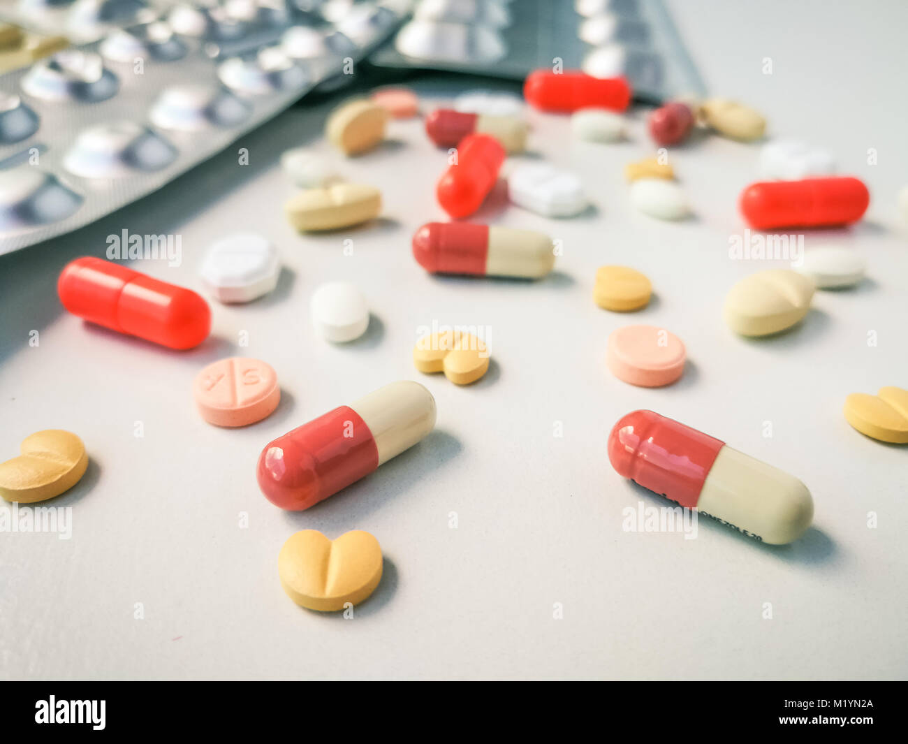 Medication white and colorful tablets arranged abstract on white color ...