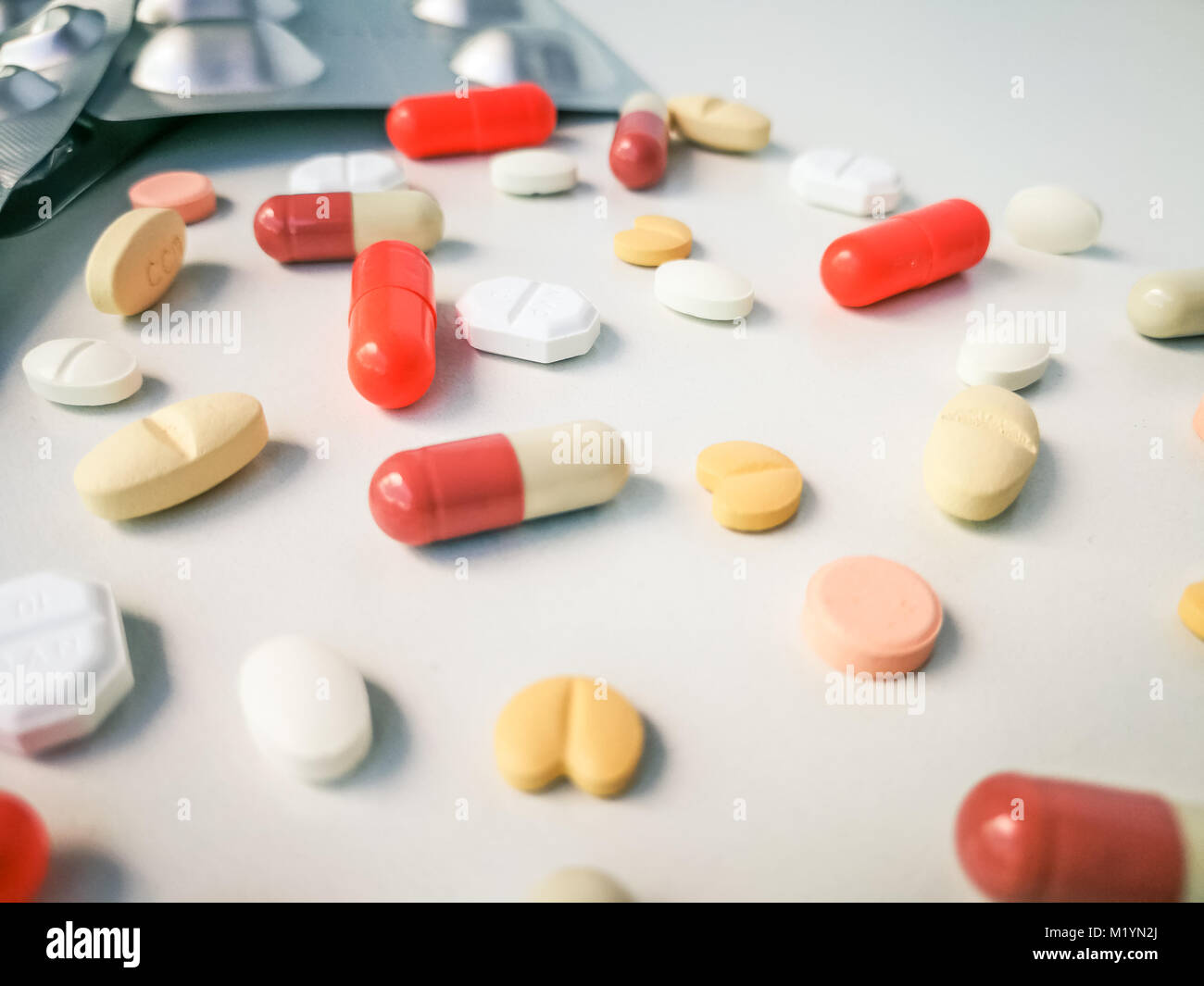 Medication white and colorful tablets arranged abstract on white color ...
