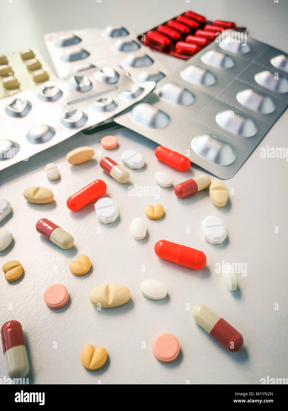 Medication white and colorful tablets arranged abstract on white color ...