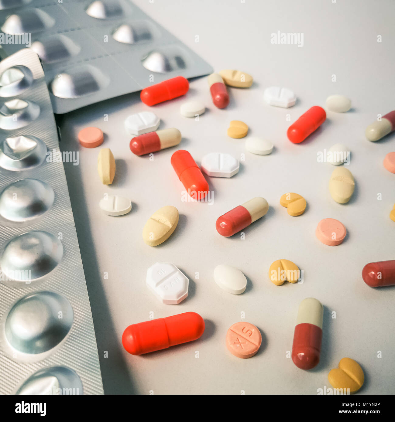Medication white and colorful tablets arranged abstract on white color ...