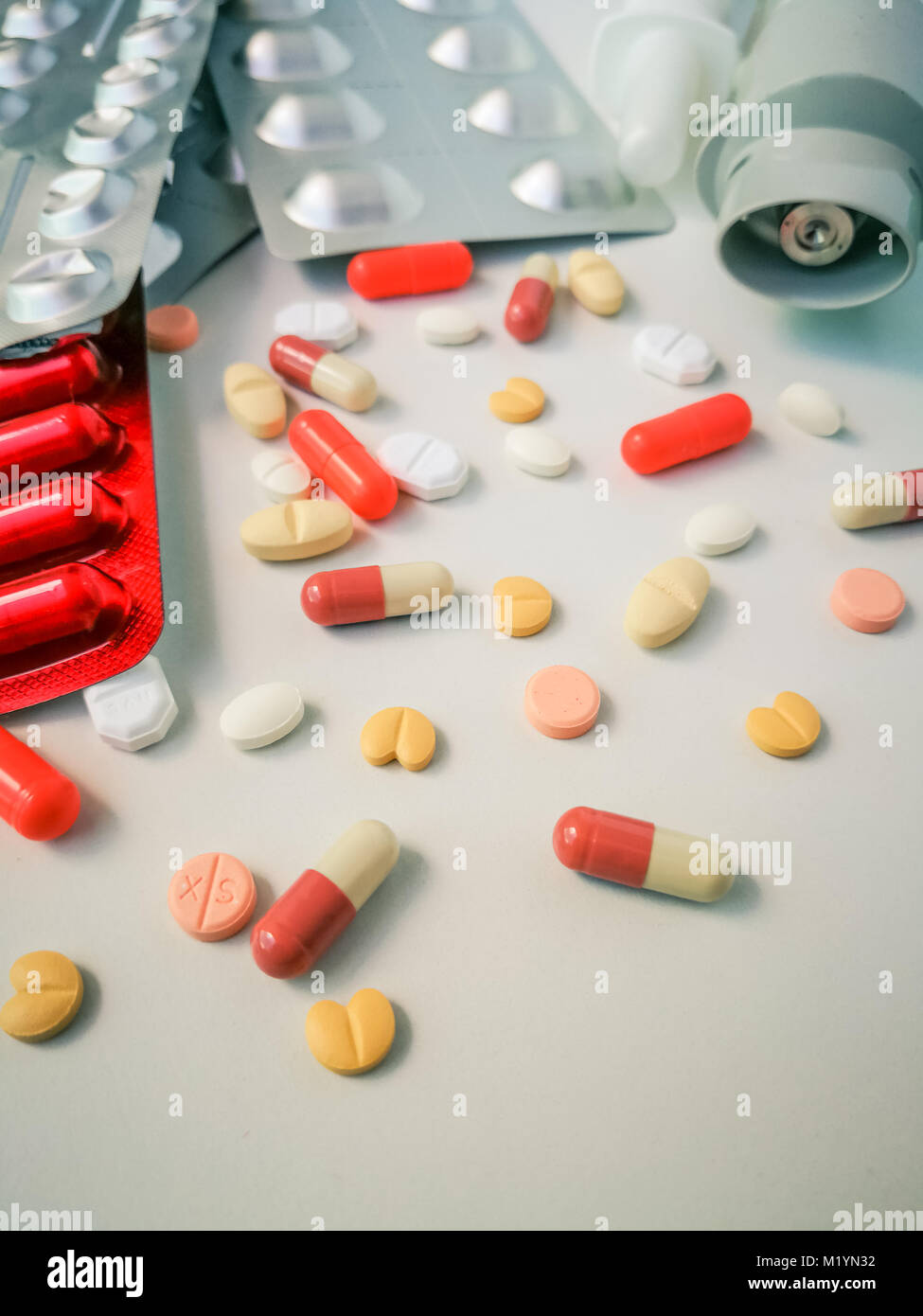 Medication white and colorful tablets arranged abstract on white color ...
