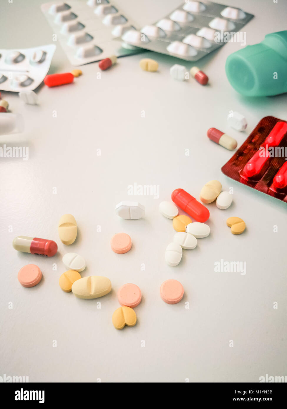 Medication white and colorful tablets arranged abstract on white color ...