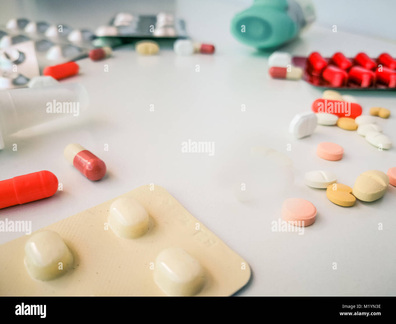 Medication white and colorful tablets arranged abstract on white color ...