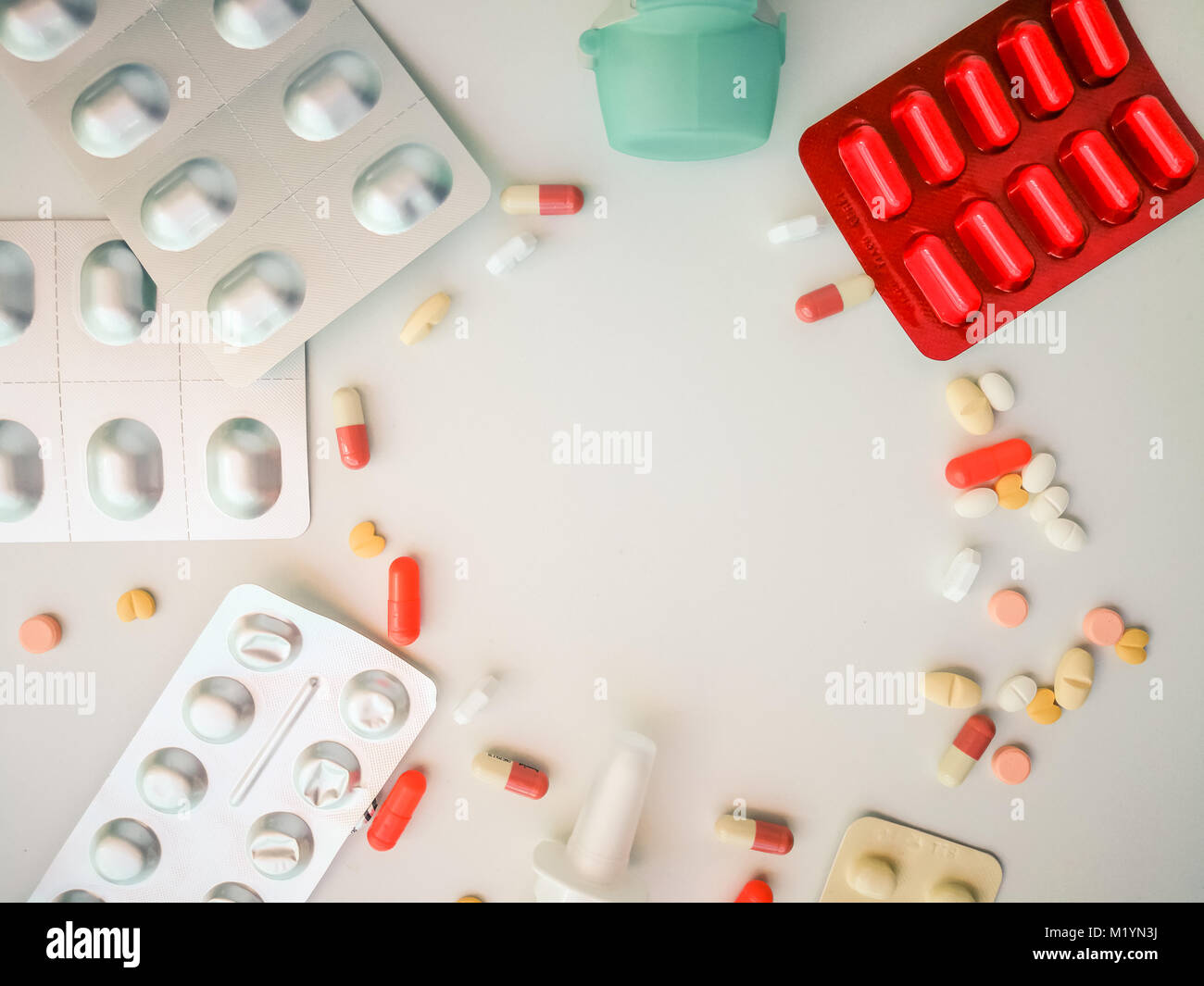 Medication white and colorful tablets arranged abstract on white color ...