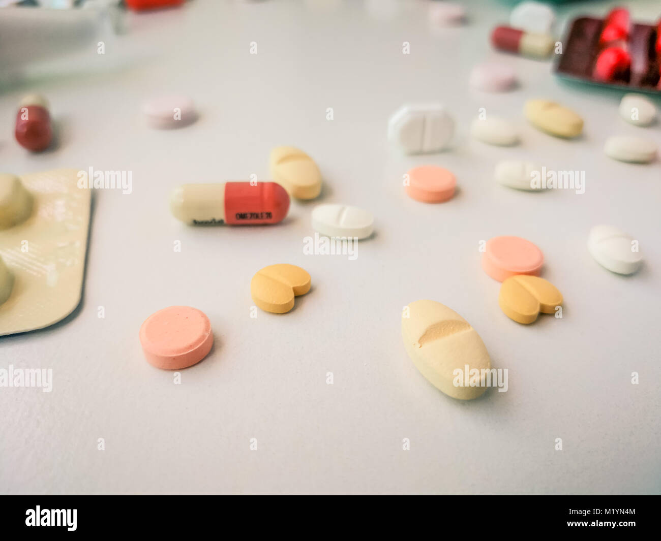 Medication white and colorful tablets arranged abstract on white color ...
