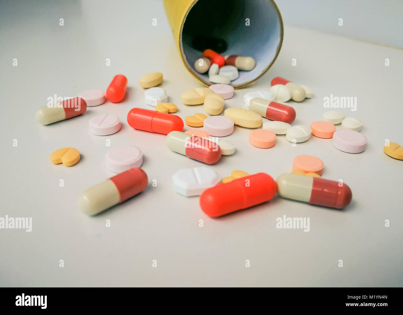 Medication white and colorful tablets arranged abstract on white color ...