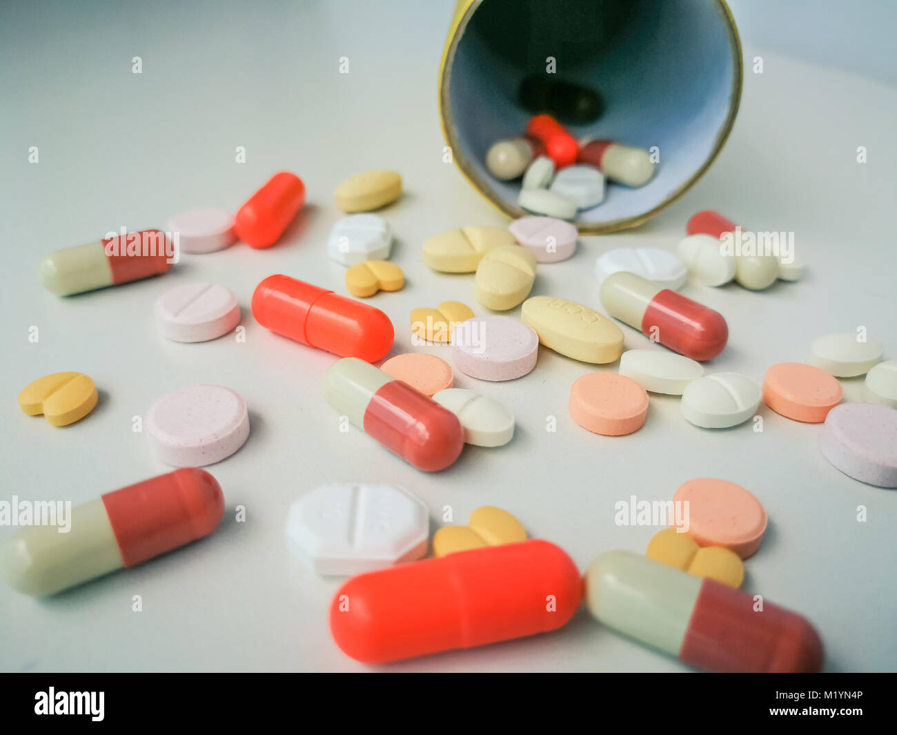 Medication white and colorful tablets arranged abstract on white color ...