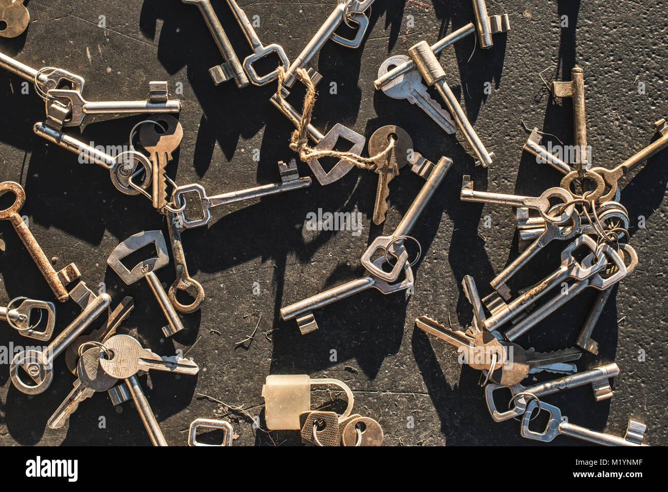 Multiple scattered keys on dark background Stock Photo - Alamy