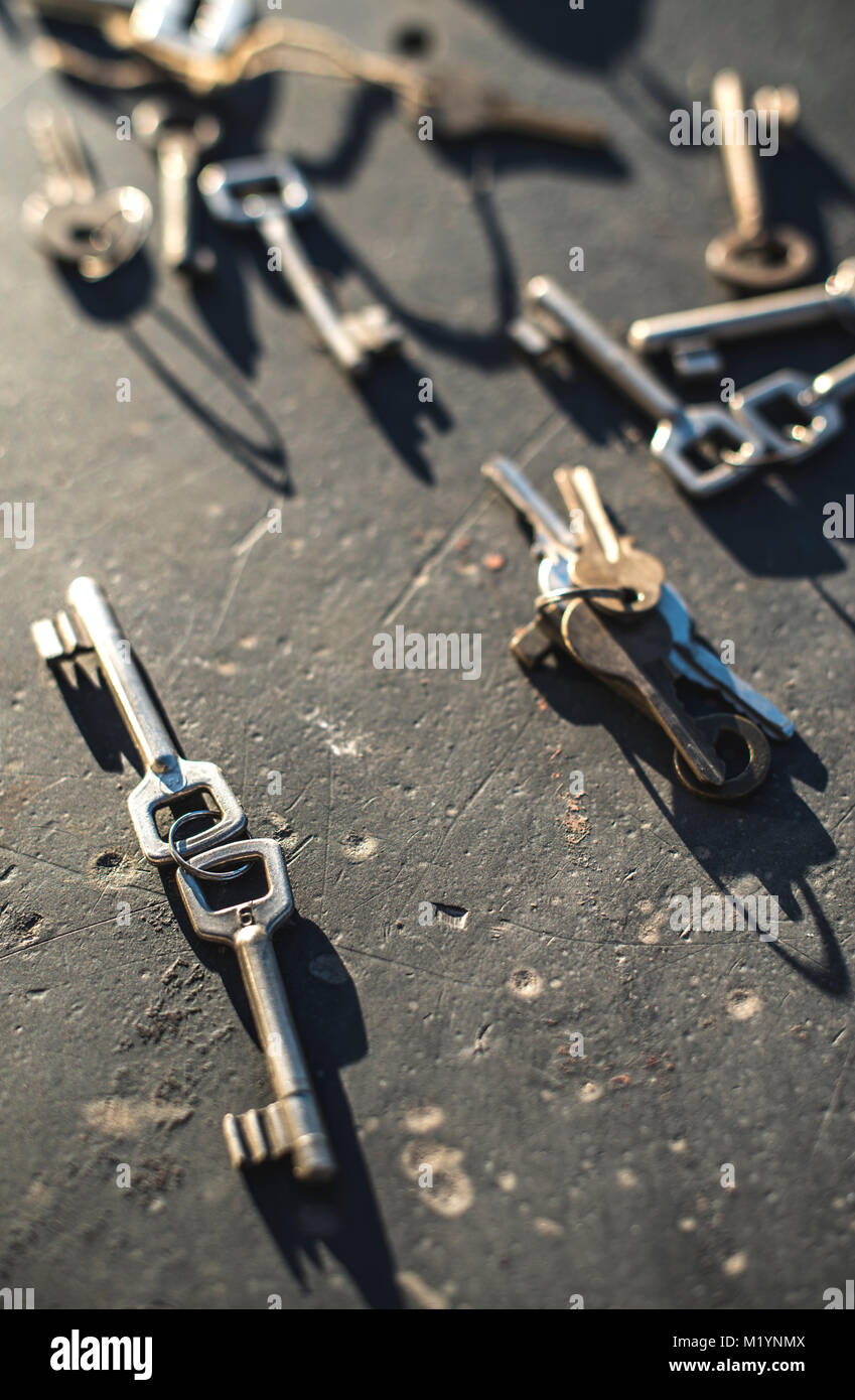 Many Keys on dark table. Sunlight Stock Photo - Alamy