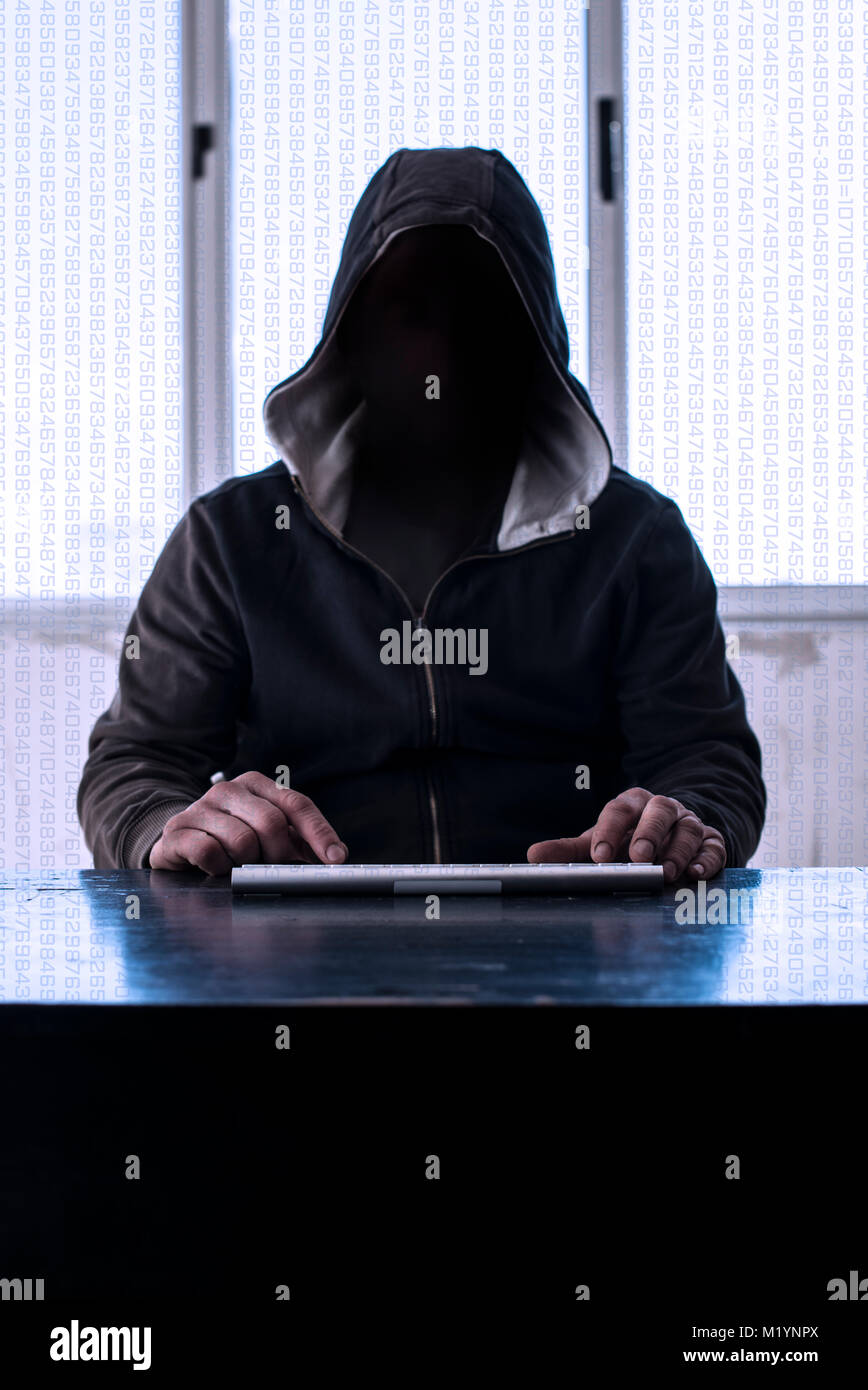 Hacker with laptop. Window in background Stock Photo - Alamy
