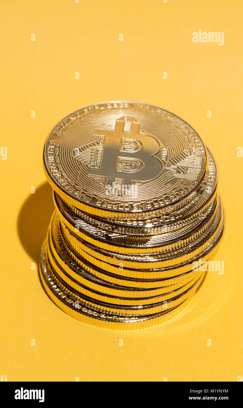 Bitcoin stack on yellow background Stock Photo - Alamy