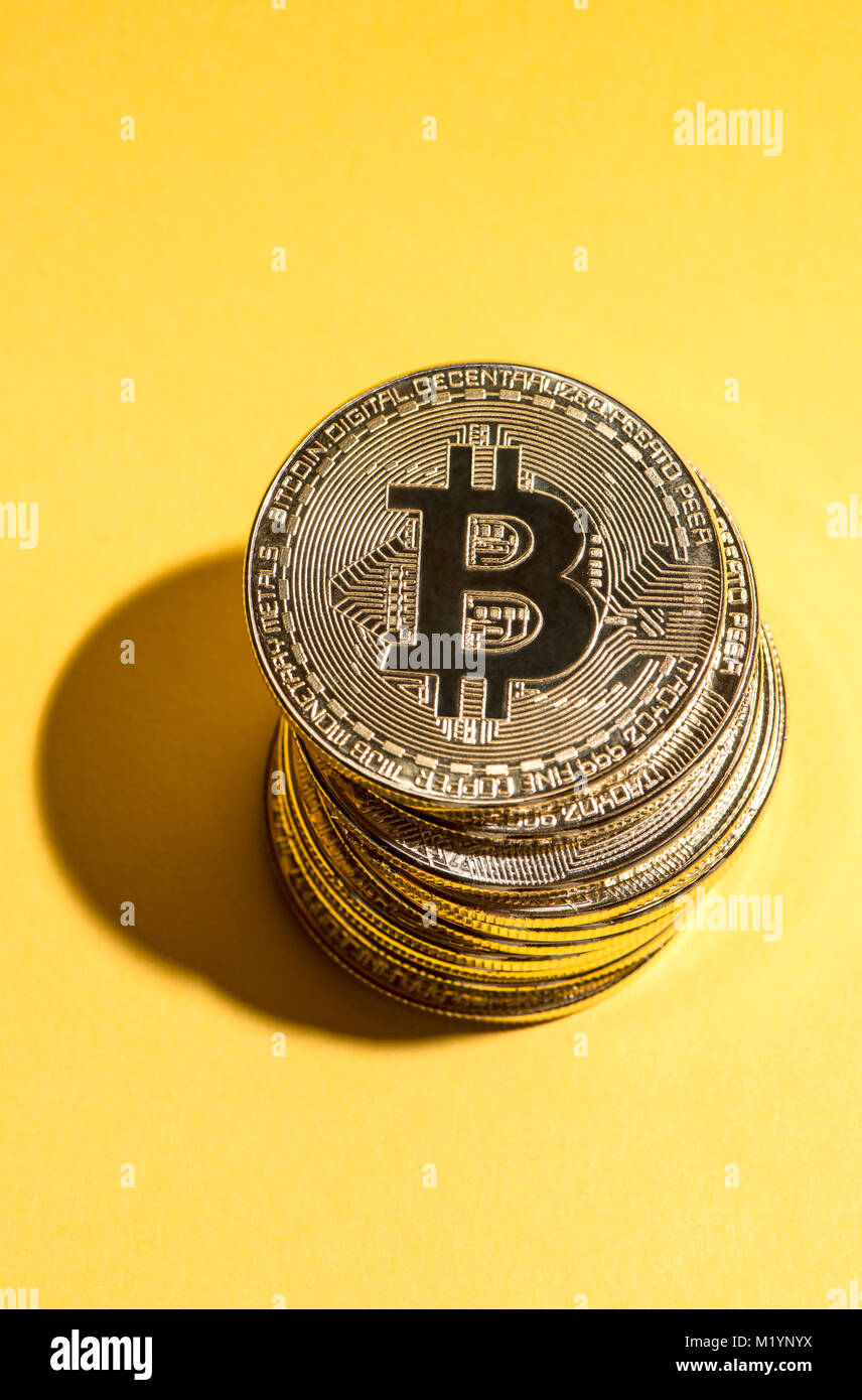 Bitcoin stack on yellow background Stock Photo - Alamy