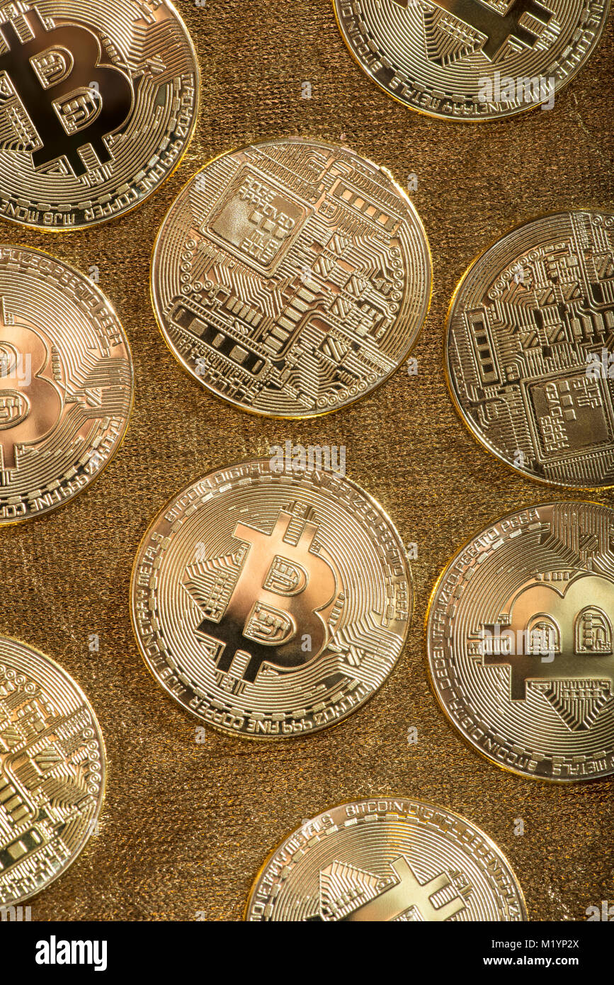 Many Bitcoin coins on gold background Stock Photo - Alamy