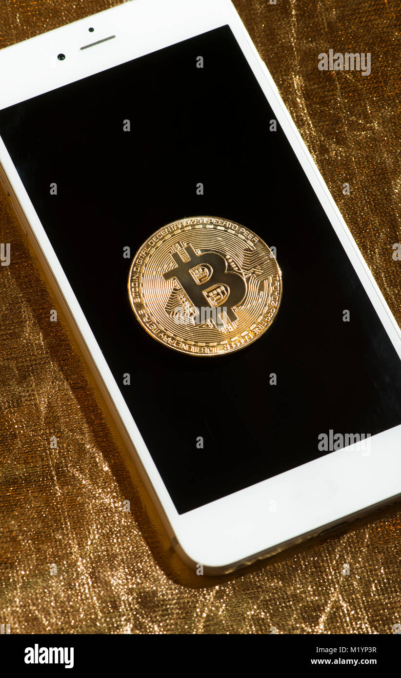 Bitcoin and smartphone on gold background Stock Photo - Alamy