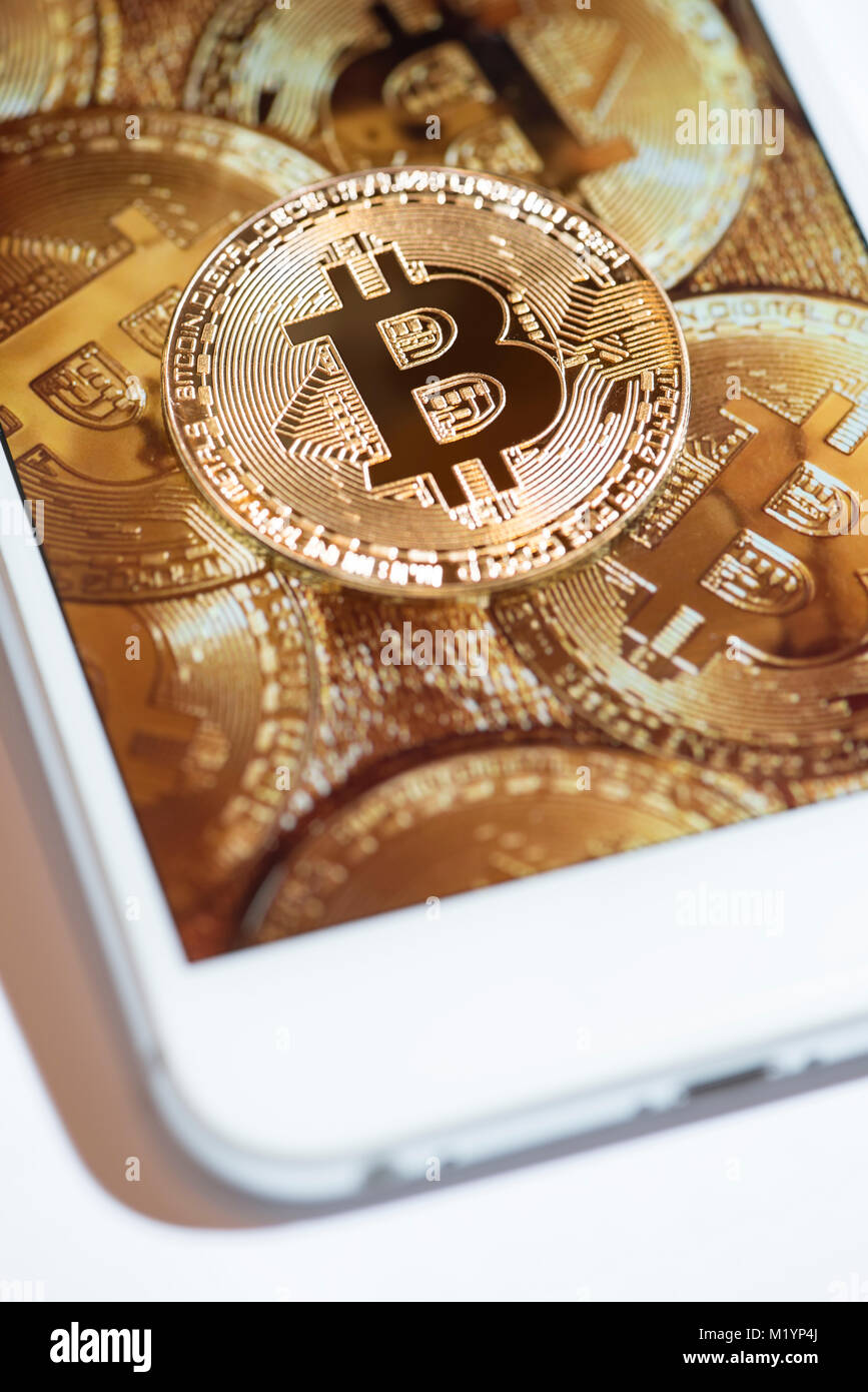 Bitcoin and smartphone on white background Stock Photo - Alamy