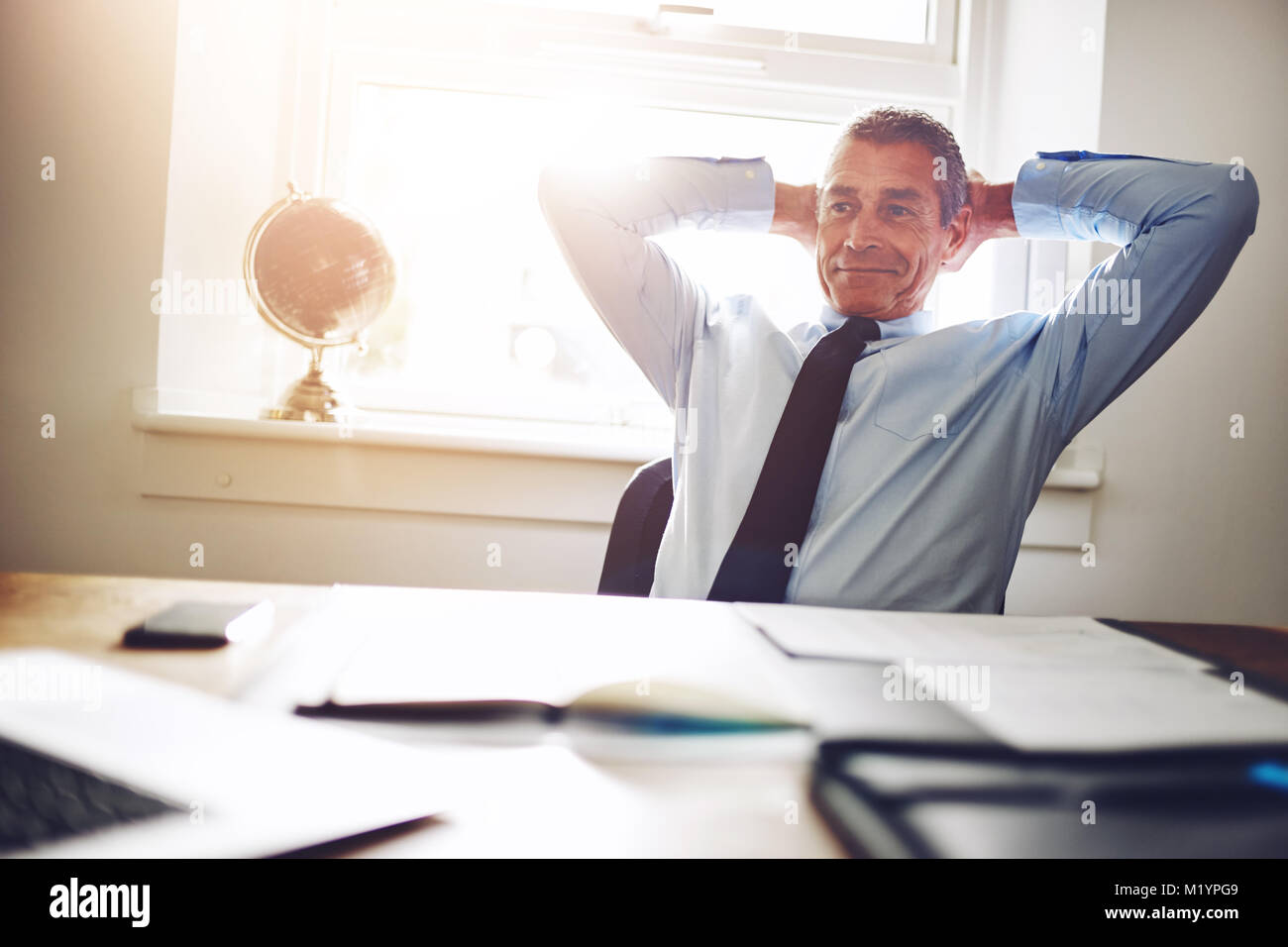 Leaning back in his chair hi-res stock photography and images - Alamy