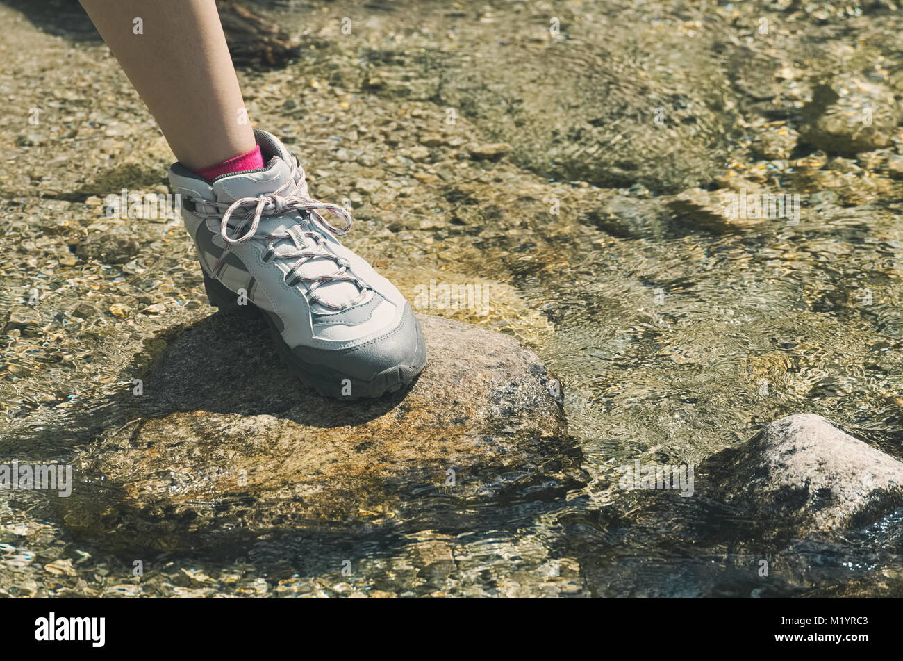 Hiker Crossing Clear Freshwater Brook on Rocks Stock Photo - Alamy