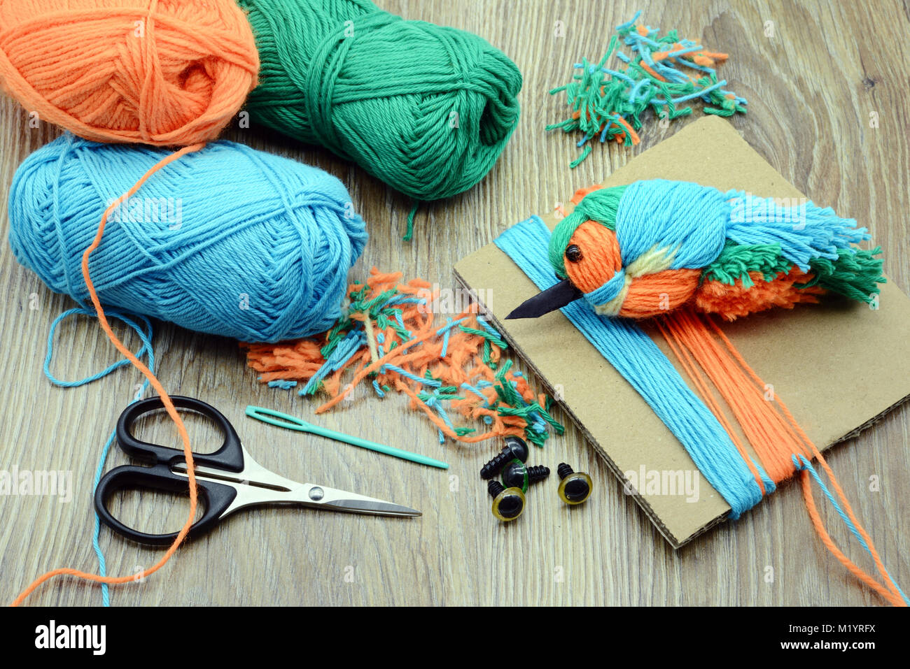 creative utensils to create yarn bird in style of kingfisher. Plastic ...