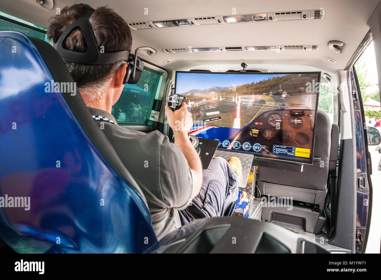 Man flying a Red Bull Air Race virtual reality plane around the race ...