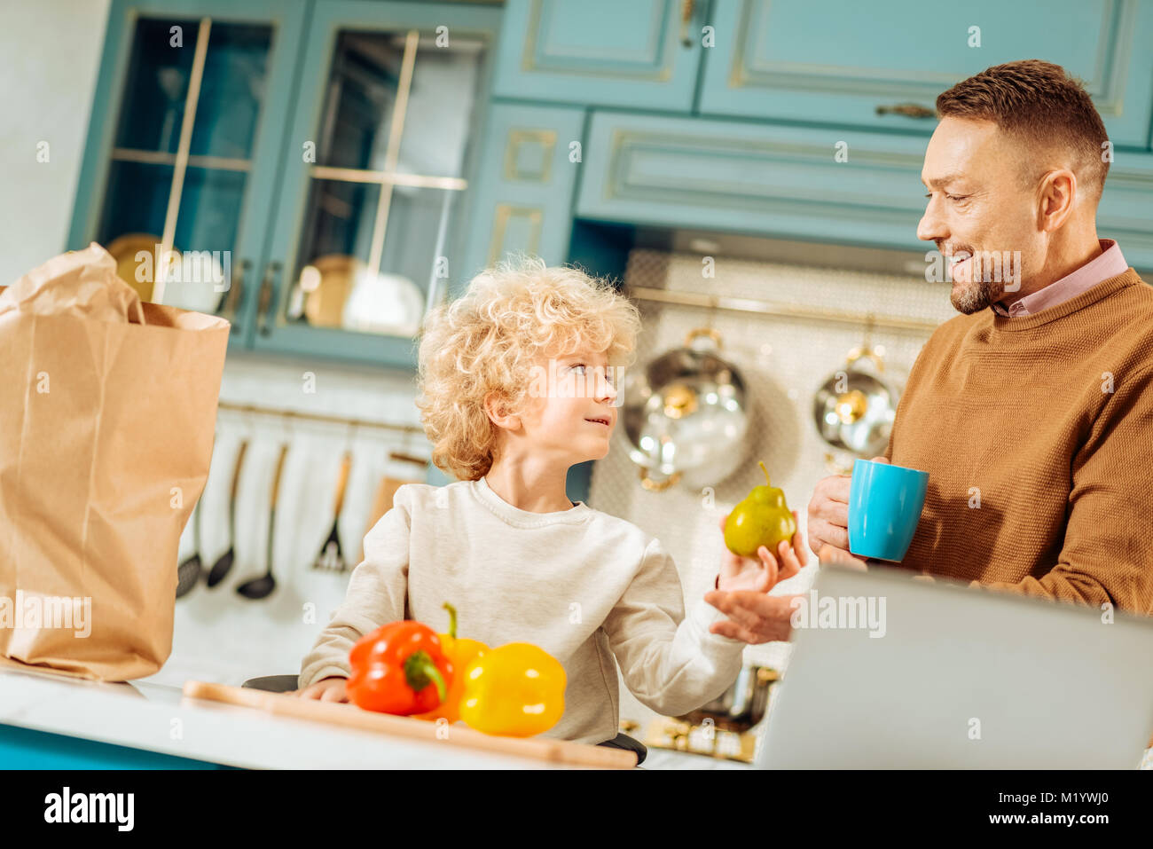 Cute positive boy looking at his father Stock Photo - Alamy