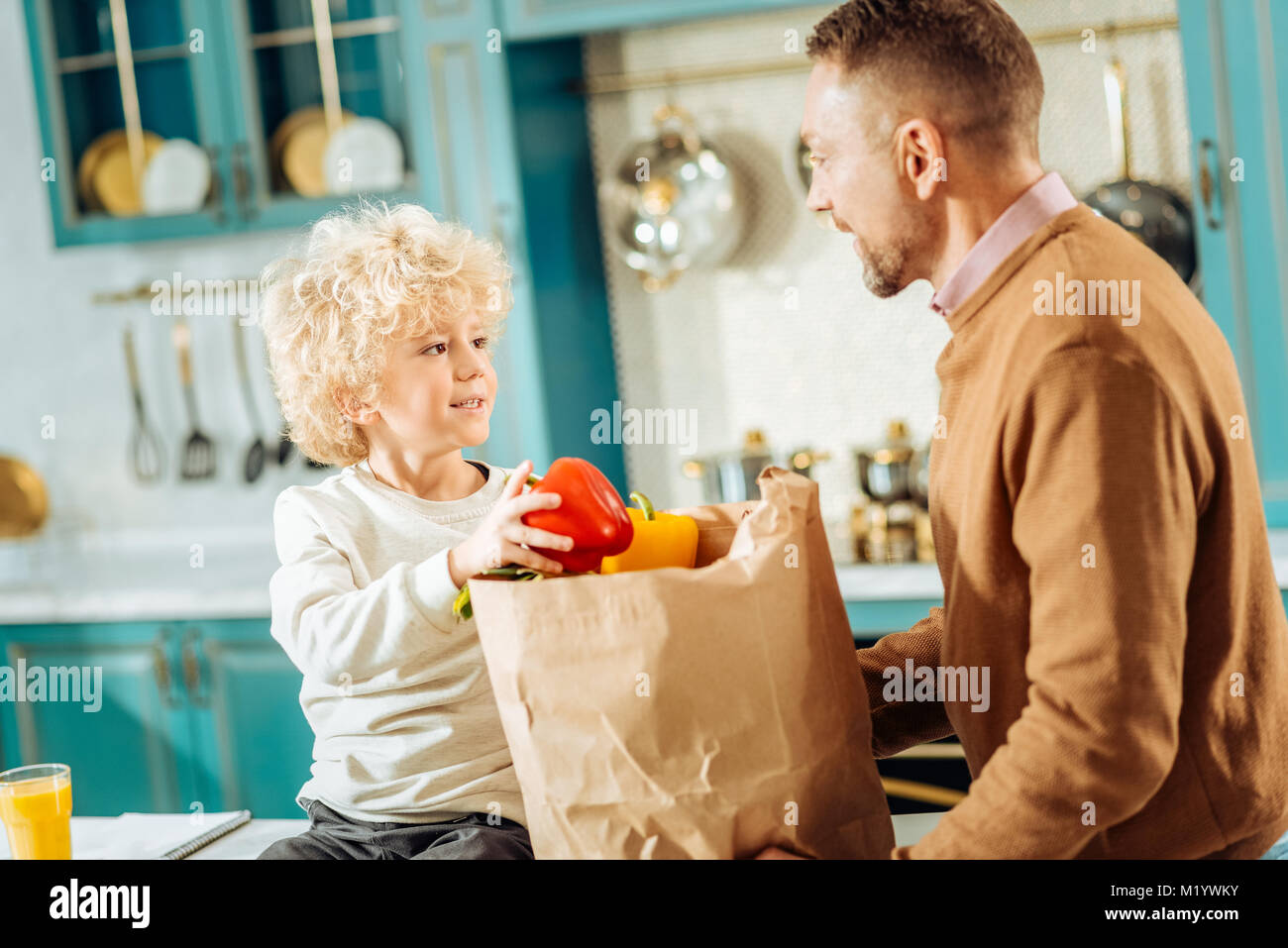 Cheerful cute boy looking at his father Stock Photo - Alamy