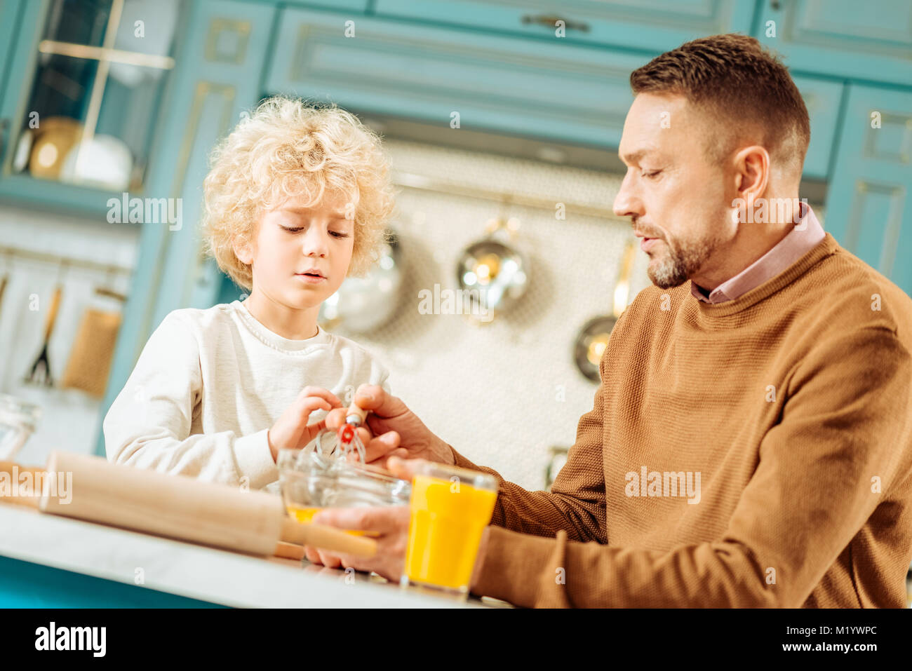 Nice caring father helping his son Stock Photo - Alamy